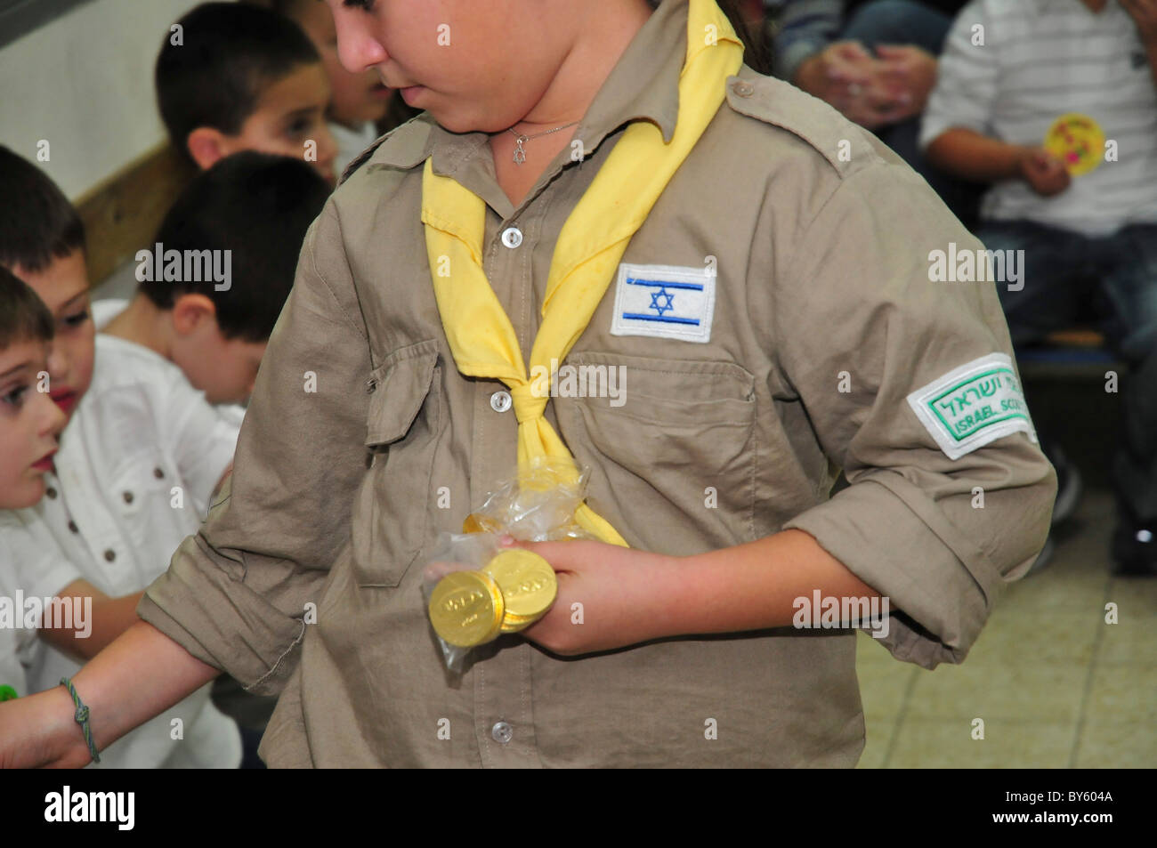 Hannukah celebration in a kindergarten in Israel Boy scout hands out ...
