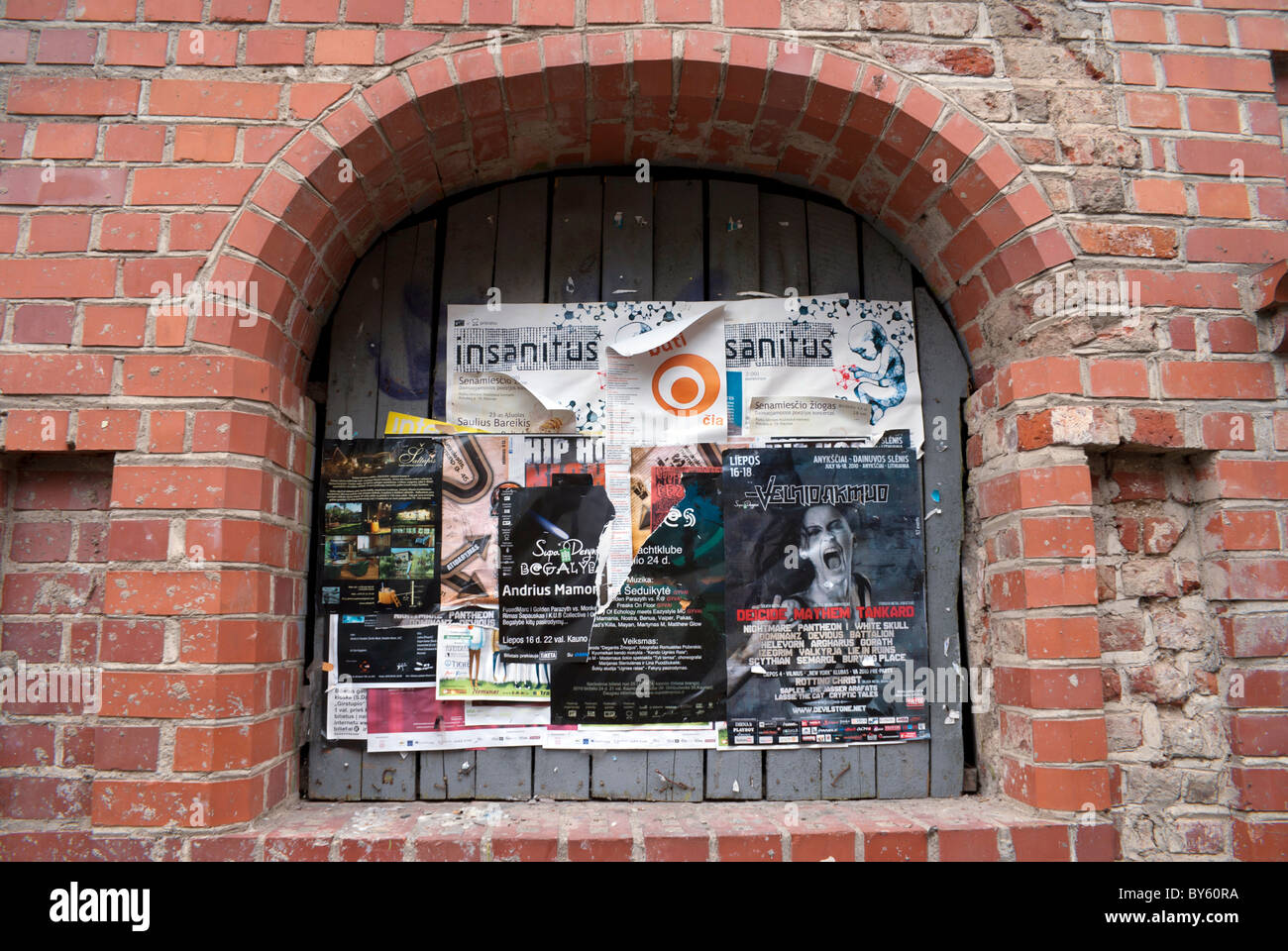 Boarded-up window with posters Stock Photo - Alamy