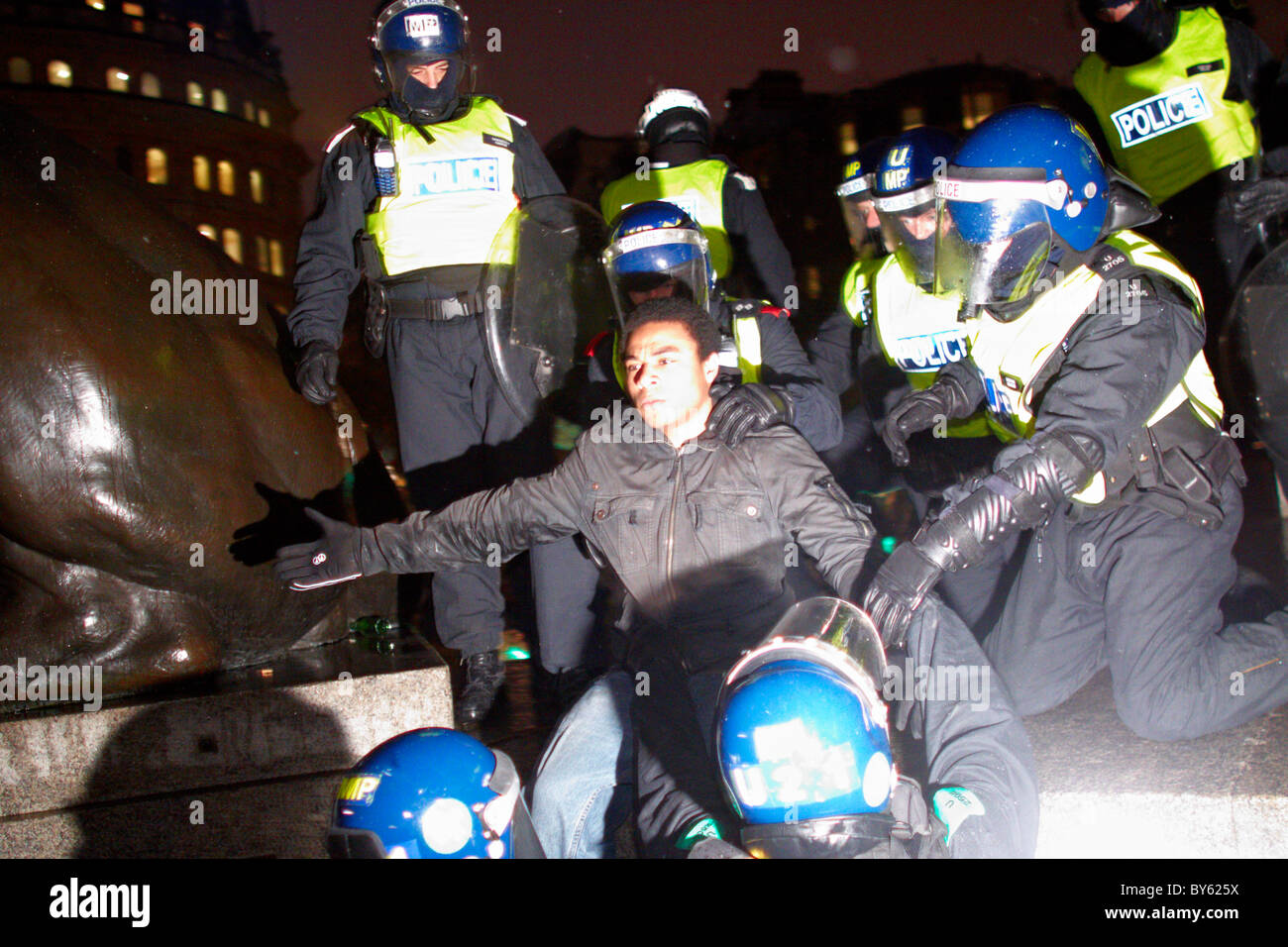 Riot police arrest a demonstrator on Nelson's Column during student ...