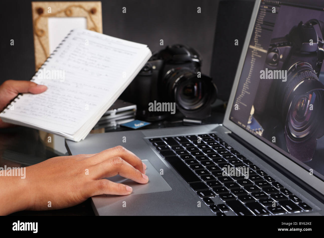 Photographer still working on the photos using laptop Stock Photo - Alamy