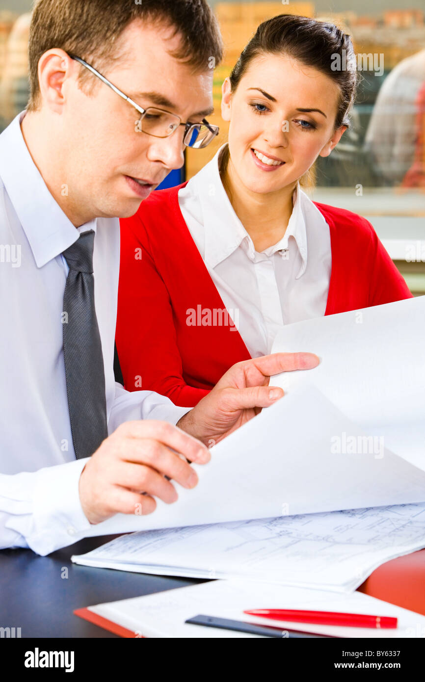 A young promising business lady looking at the business plan listening ...