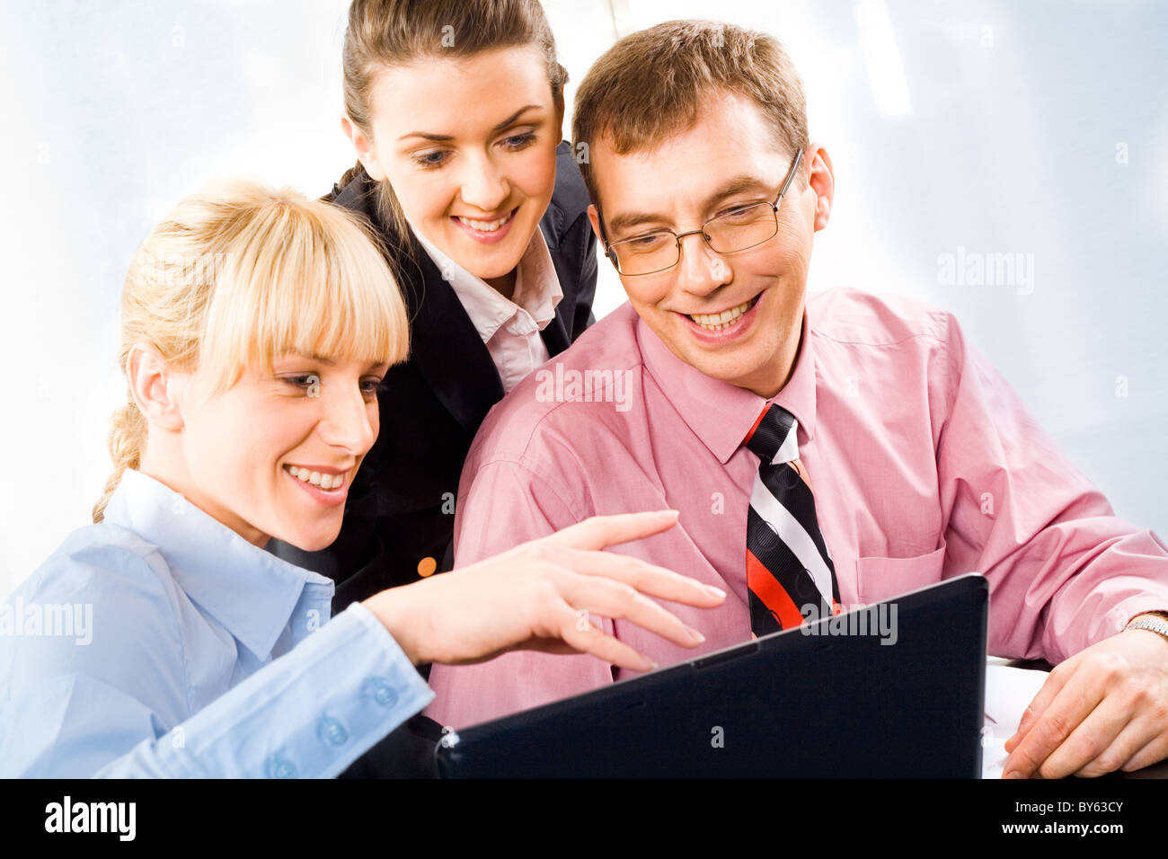 Portrait of three business people working together Stock Photo - Alamy