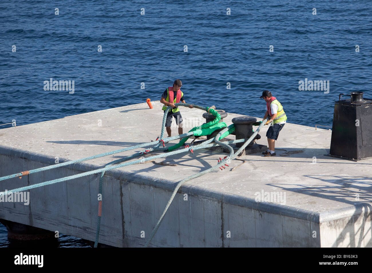 Harbour workers casting off the mooring lines of the passenger ship ...