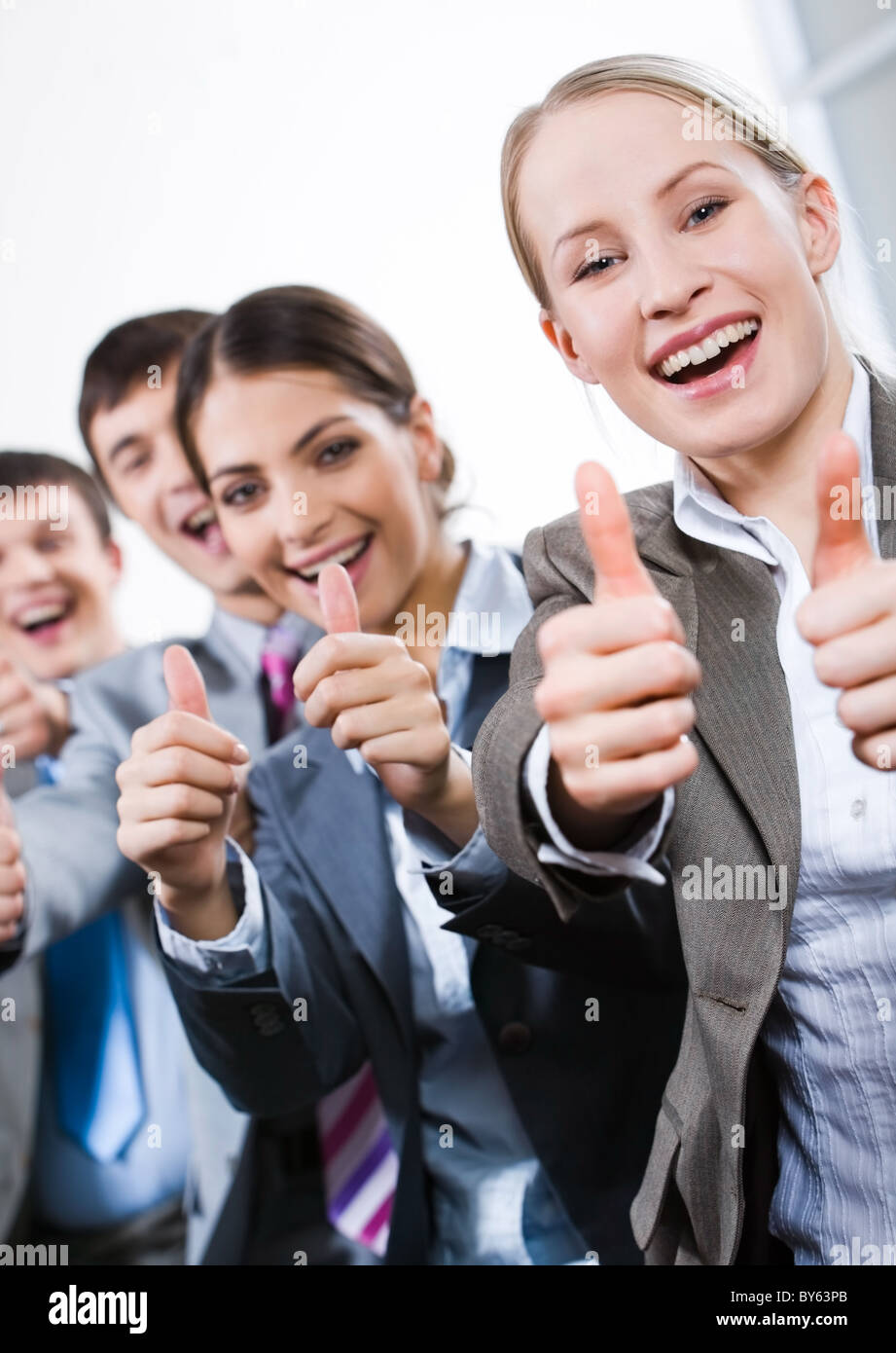 Vertical image of business people giving the thumbs-up sign Stock Photo ...