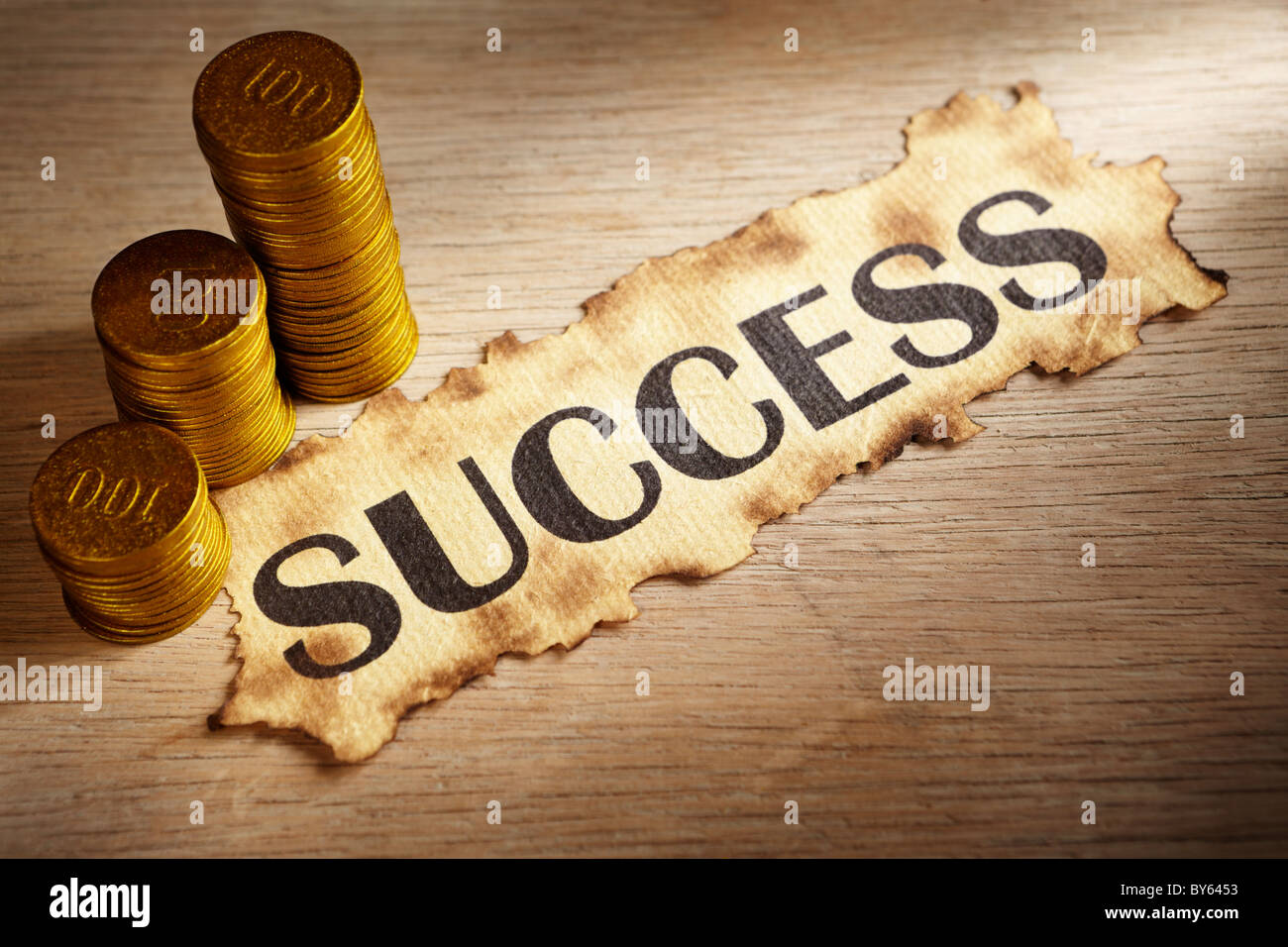 Success written on vintage paper and stack of gold coins Stock Photo ...