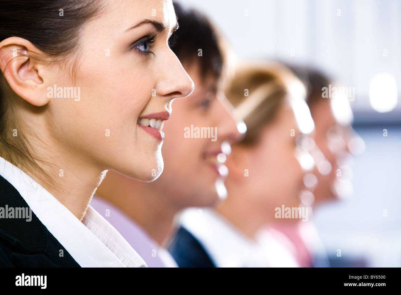 Line of half faces of young smiling specialists Stock Photo - Alamy