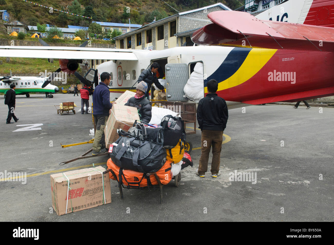 small plane landing on the dangerous and tiny Lukla airstrip in the ...