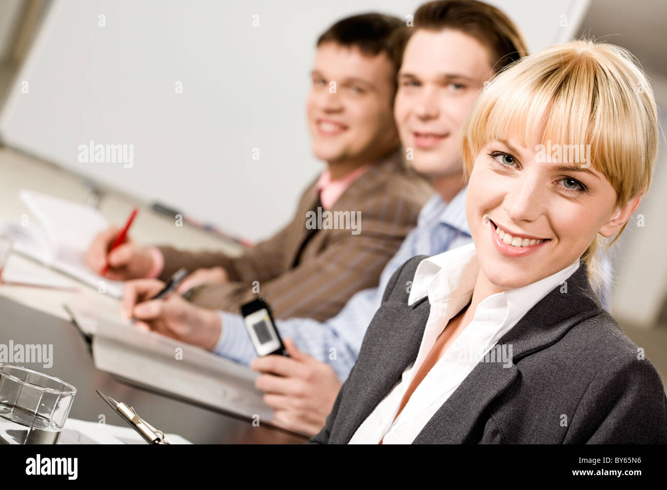 Portrait of pretty employee looking at camera on the background of ...