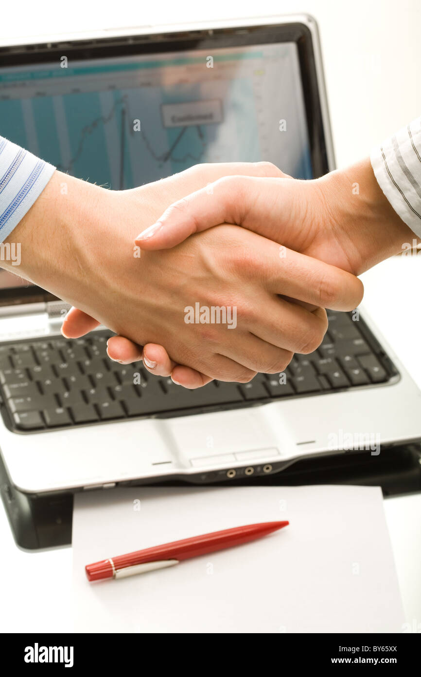 Handshake of business people on the background of laptop Stock Photo ...