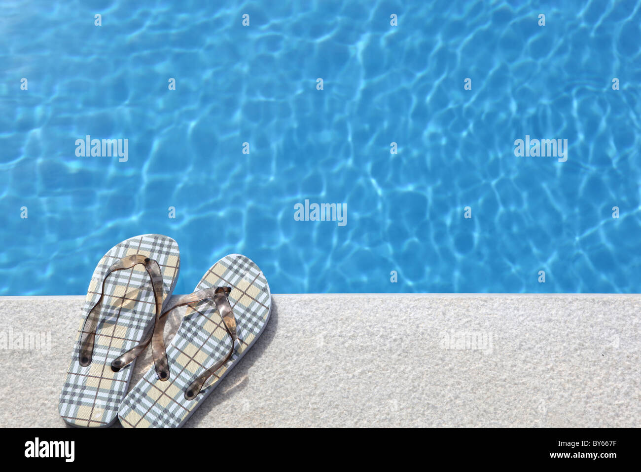Flip flops beside a swimming pool Stock Photo - Alamy
