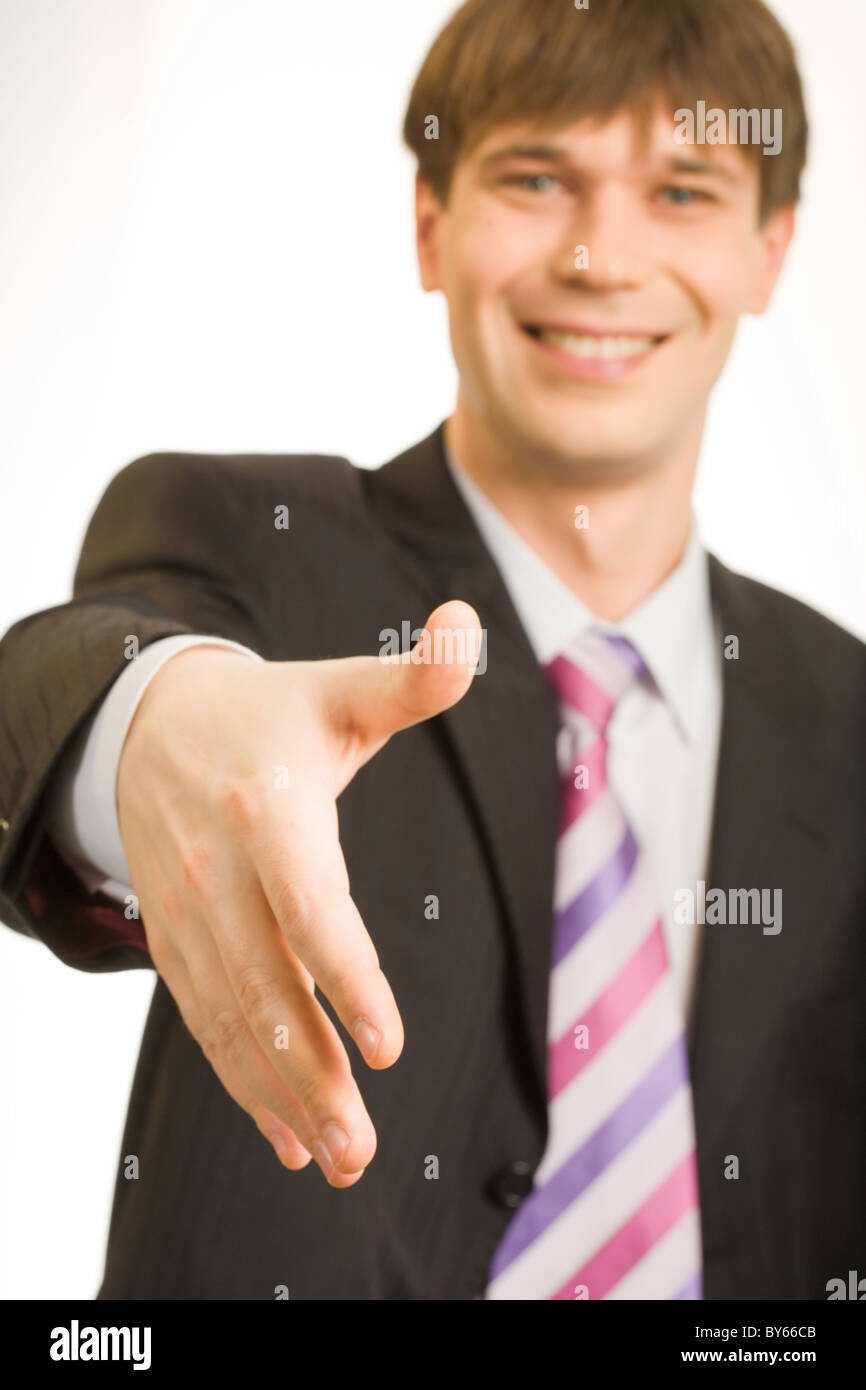 A man extending his hand to the business partner with a smile Stock ...
