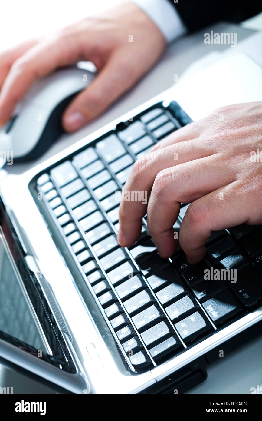 Vertical image of human hands typing a letter Stock Photo - Alamy