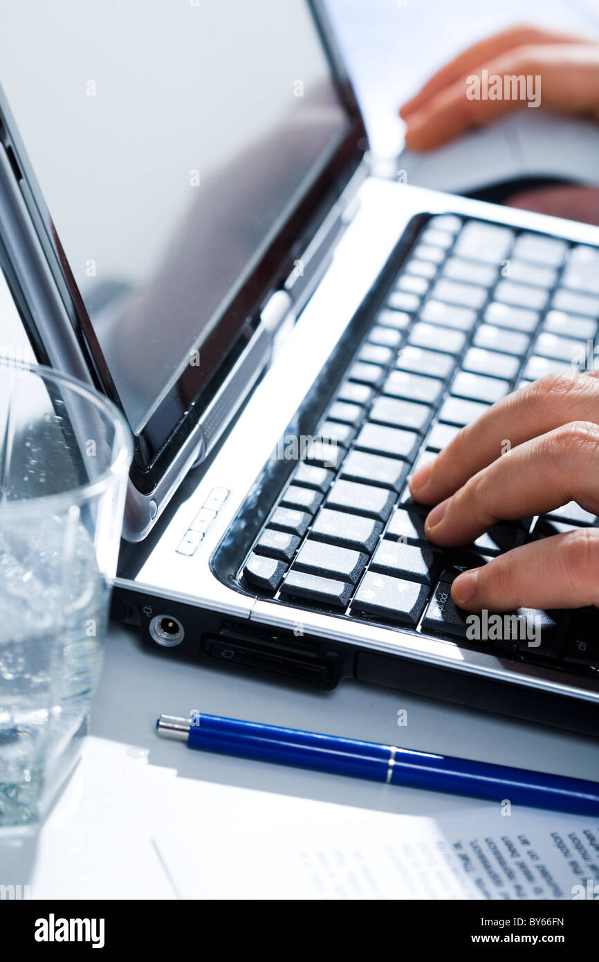 Image of human hands pressing the buttons of keyboard with pen and ...