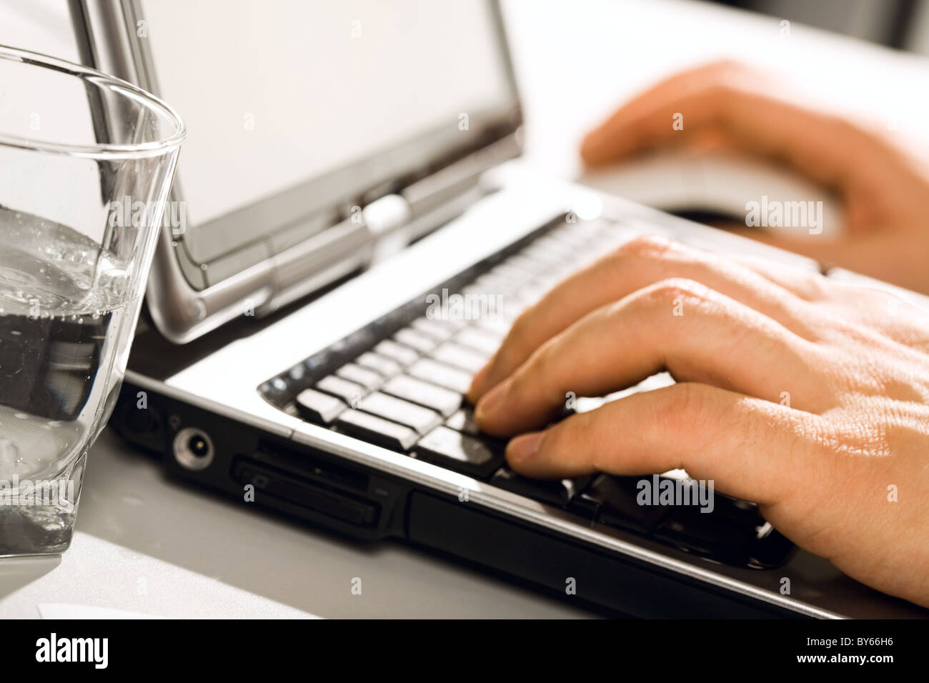 Close-up of male hands typing a letter on keyboard of laptop Stock ...