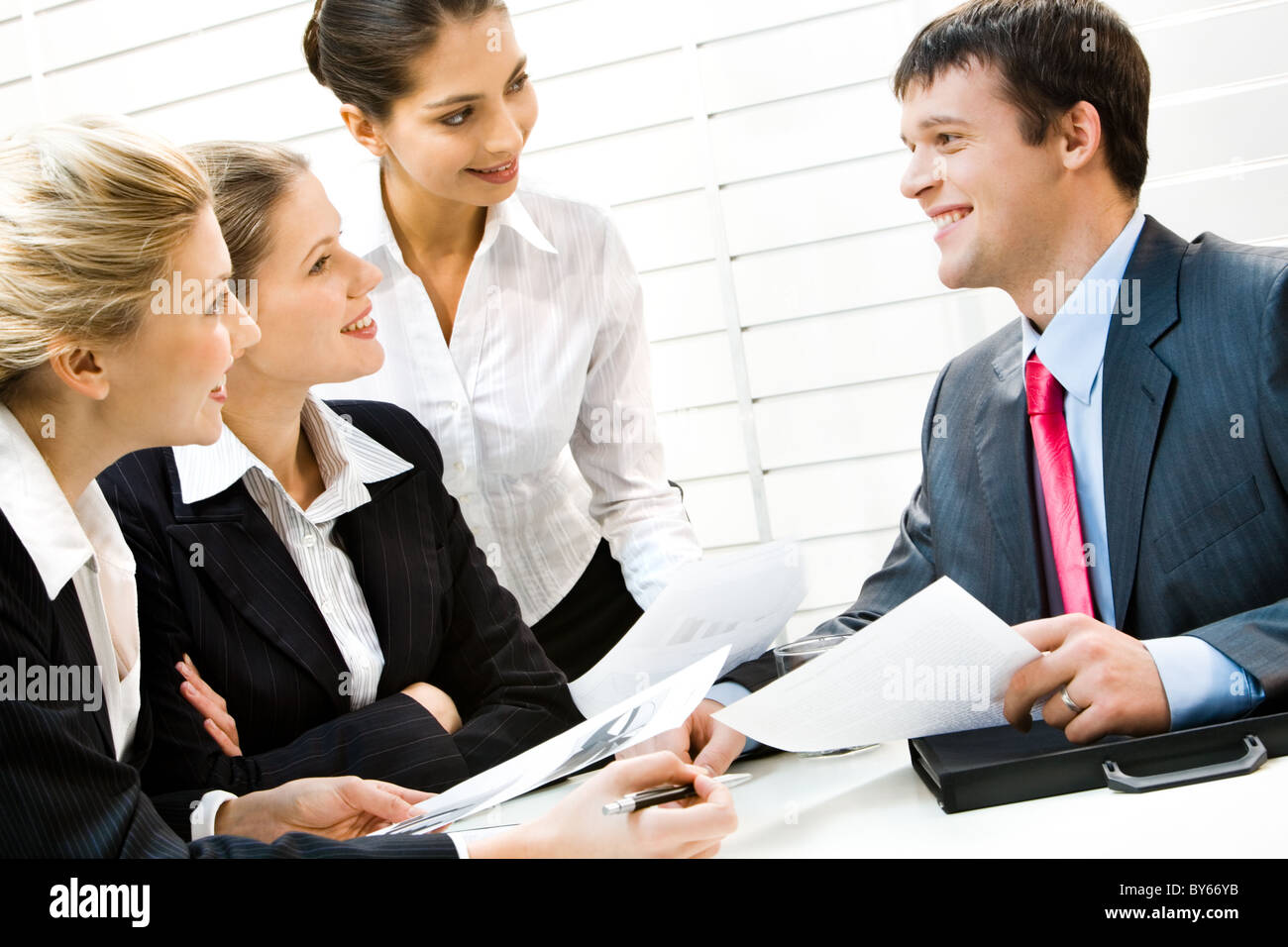 Portrait of confident boss giving business directions to co-workers ...