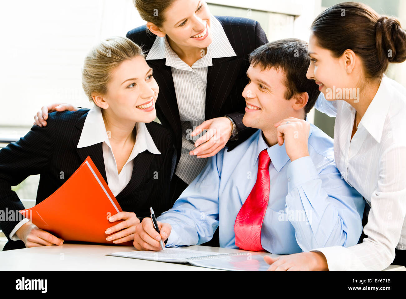Portrait of four business people discussing a new plan Stock Photo - Alamy