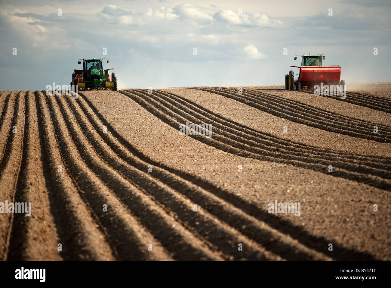 Image of two tractors planting farm fields Stock Photo - Alamy