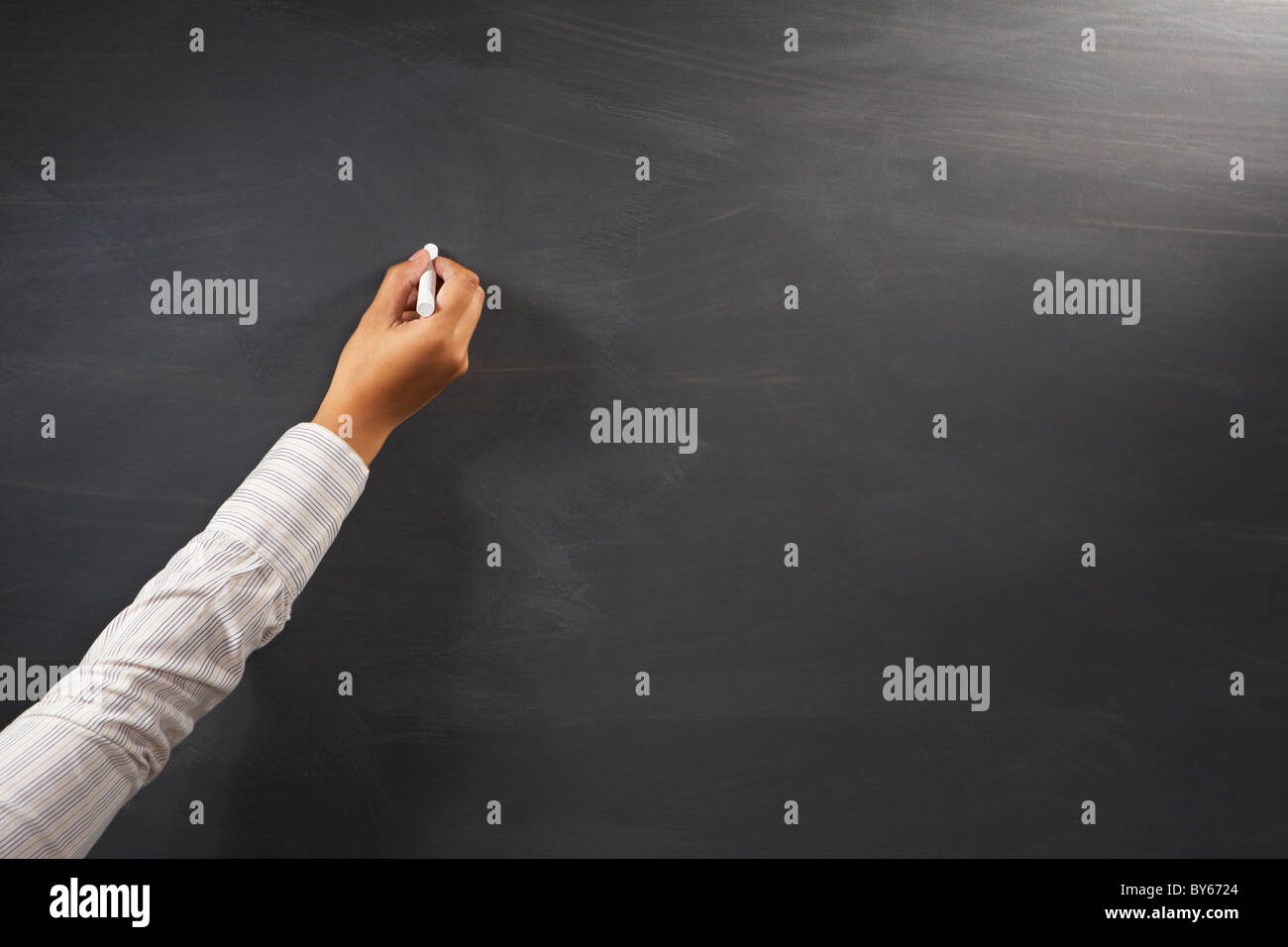 Hand of teacher holding chalk in front of blank blackboard Stock Photo ...