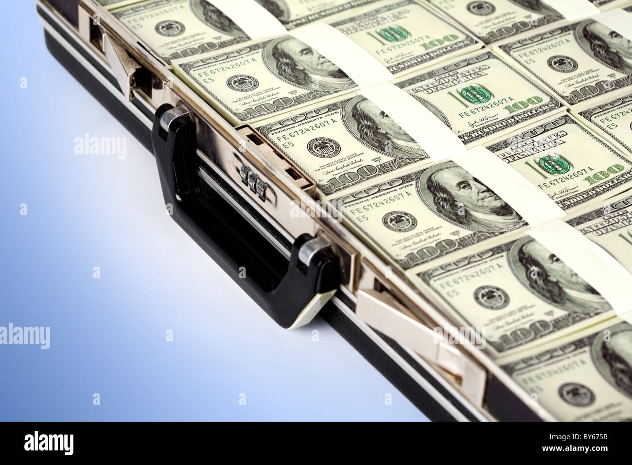 Image of million dollars packing a suitcase on a blue background Stock ...