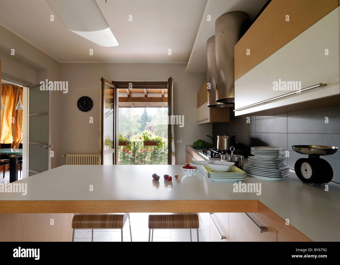 white table with dishes in a modern kitchen and open window Stock Photo ...