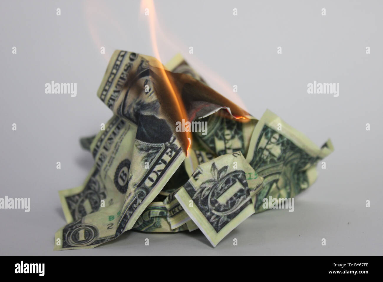 burning dollars on a white background with a close range Stock Photo ...