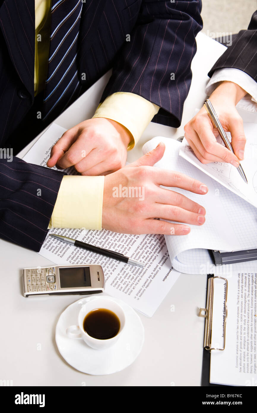 Having some coffee during business conversation Stock Photo - Alamy
