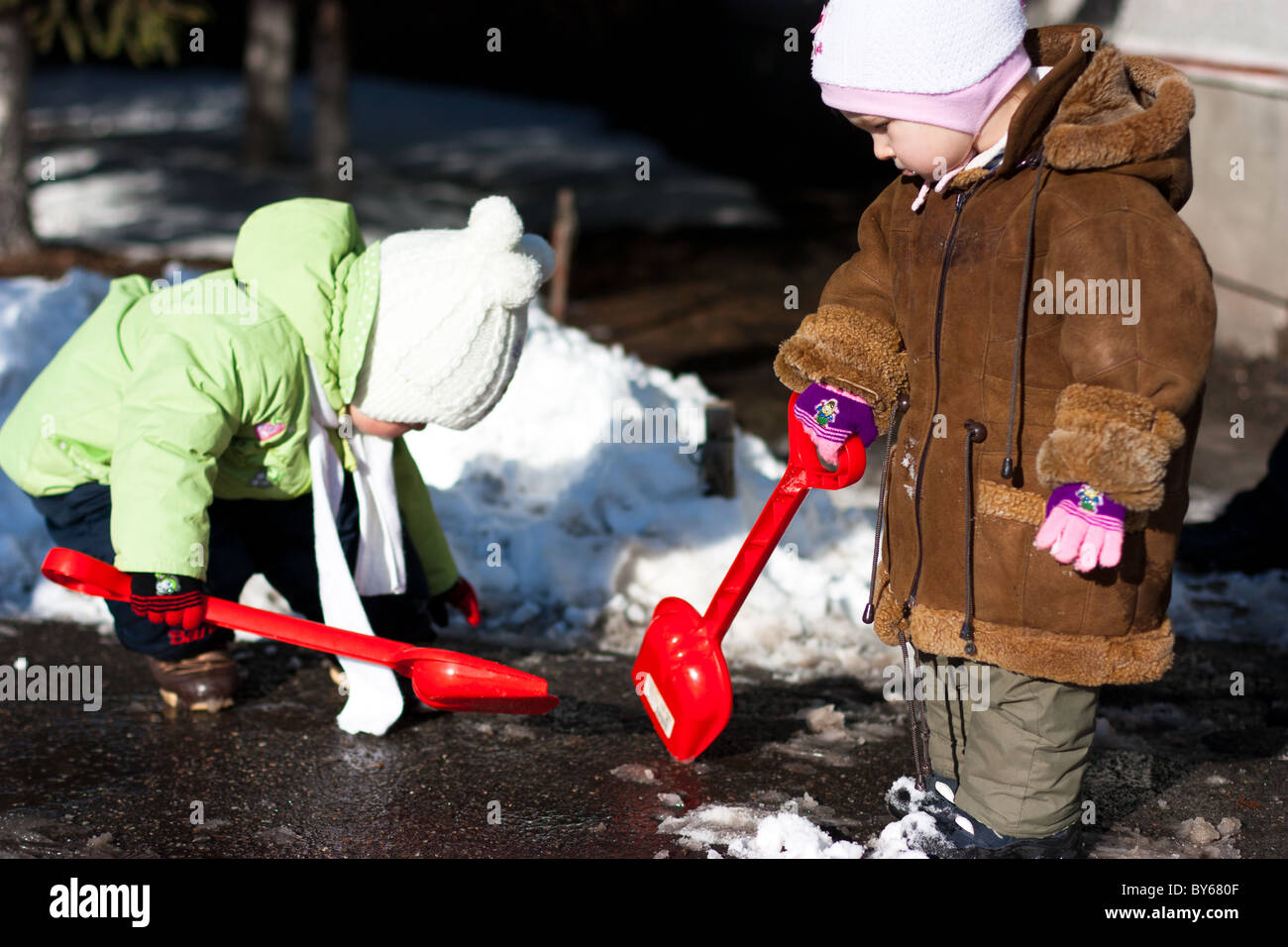 Children playing with spades outdoor in winter Stock Photo - Alamy