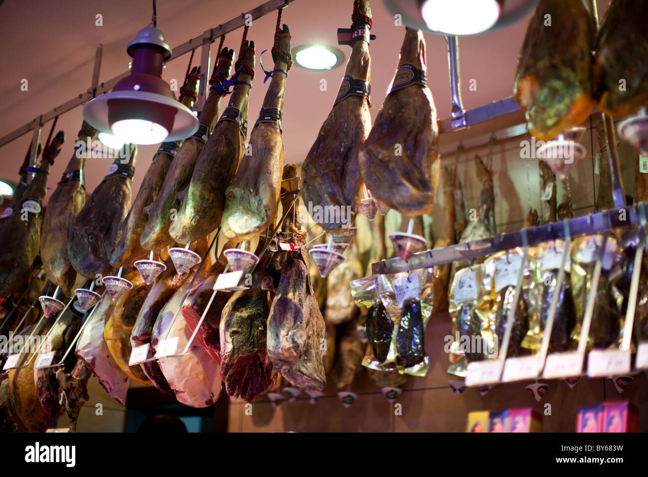 Serrano Ham legs hanging in a shop in Toledo Spain Stock Photo - Alamy