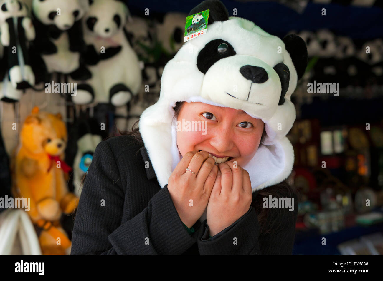 Beautiful Chinese girl having fun in panda fur hat at Chengdu Research ...