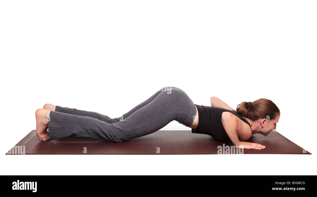 Isolated studio shot of a fit Caucasian woman holding the ashtanga ...