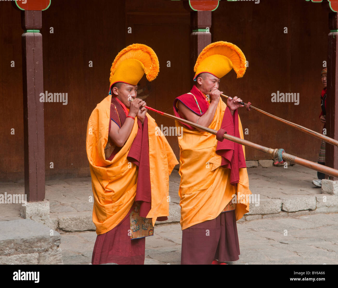 yellow hat Gelugpa monks blowing horns at the Mani Rimdu Festival at ...