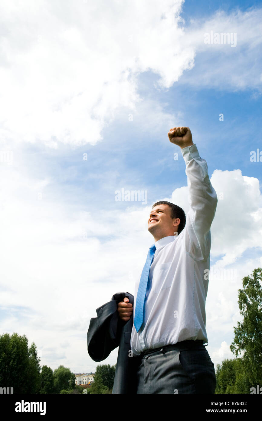 Portrait of happy man standing outside in rural environment with his ...