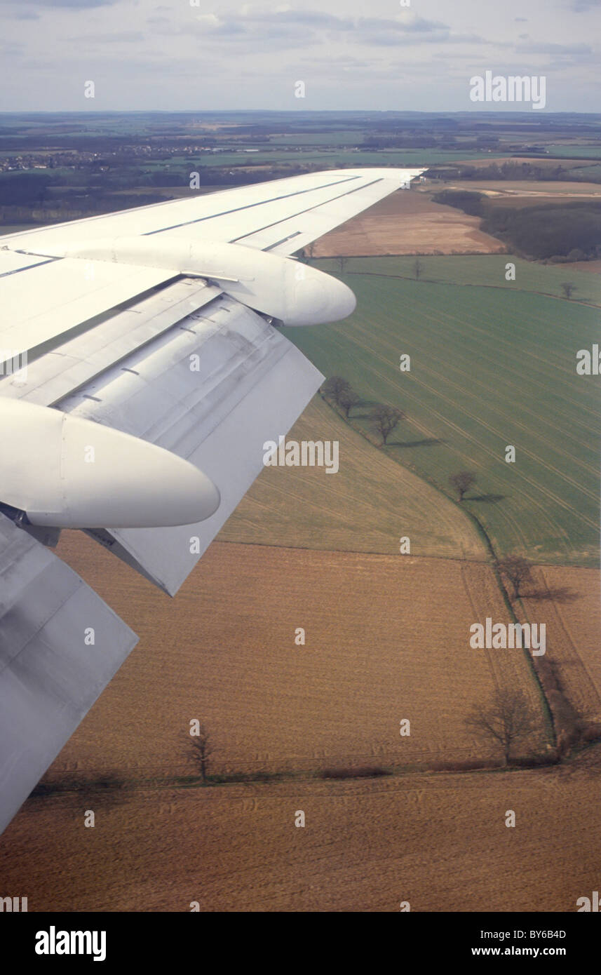 Passenger airplane wing flaps in operation during aeroplane landing ...