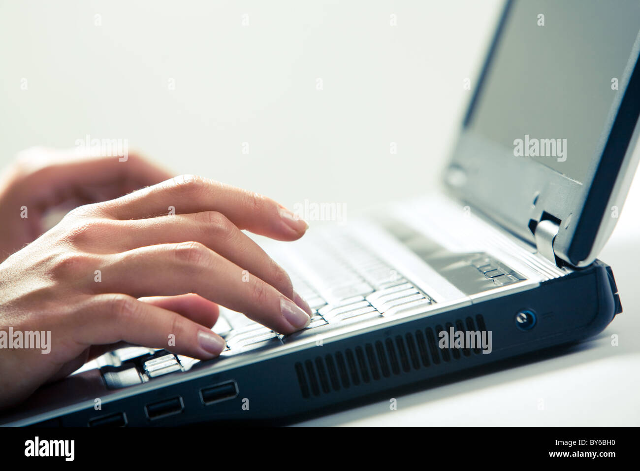 Image of human hands typing on laptop Stock Photo - Alamy