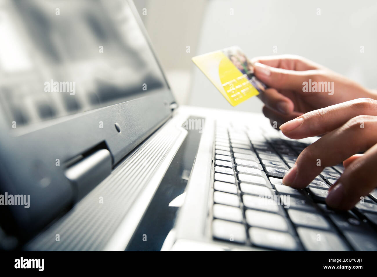 Image of hands holding credit card and pressing a keys of keyboard ...