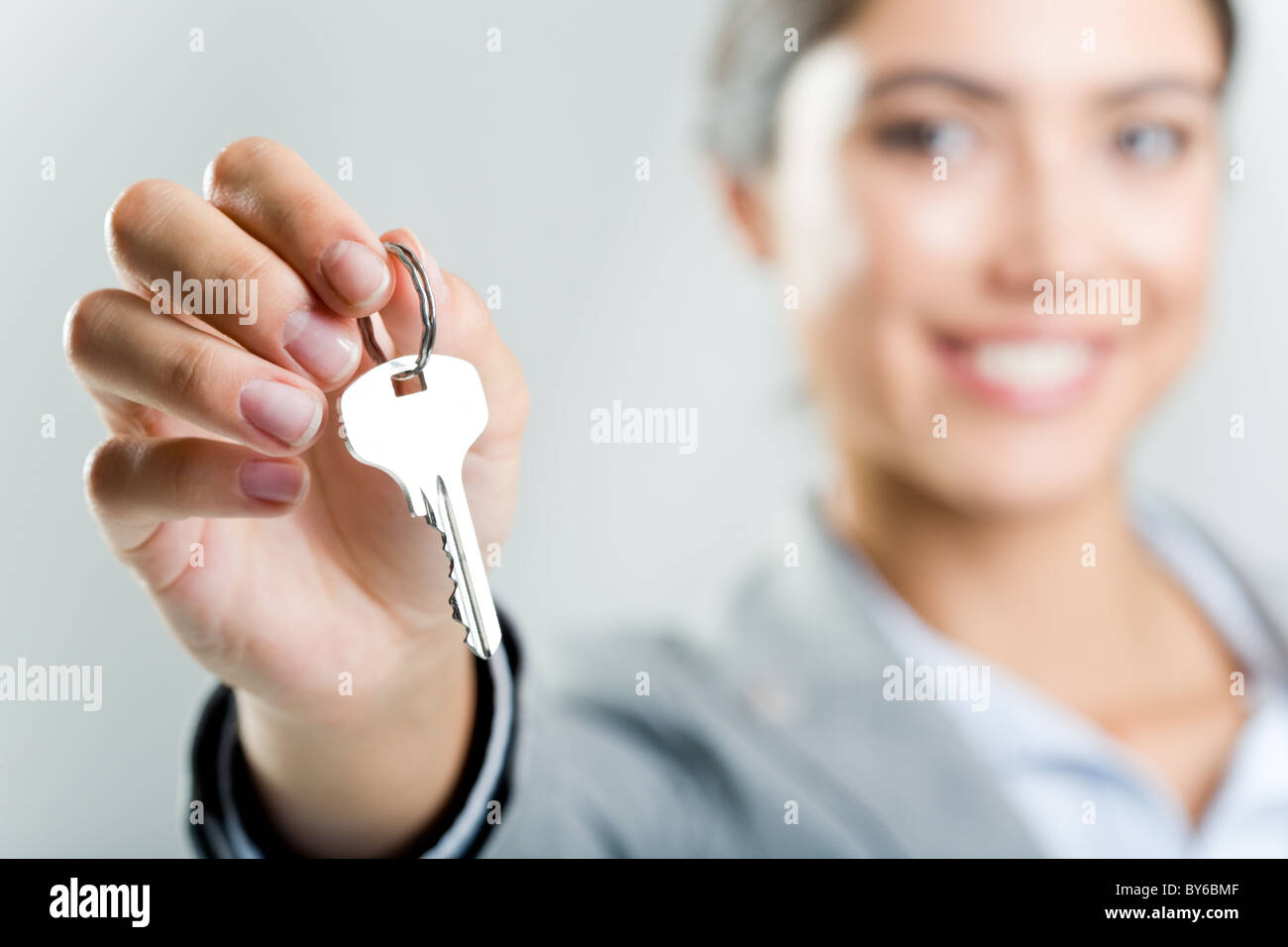 Photo of happy woman’s hand holding new key and pointing it at camera ...