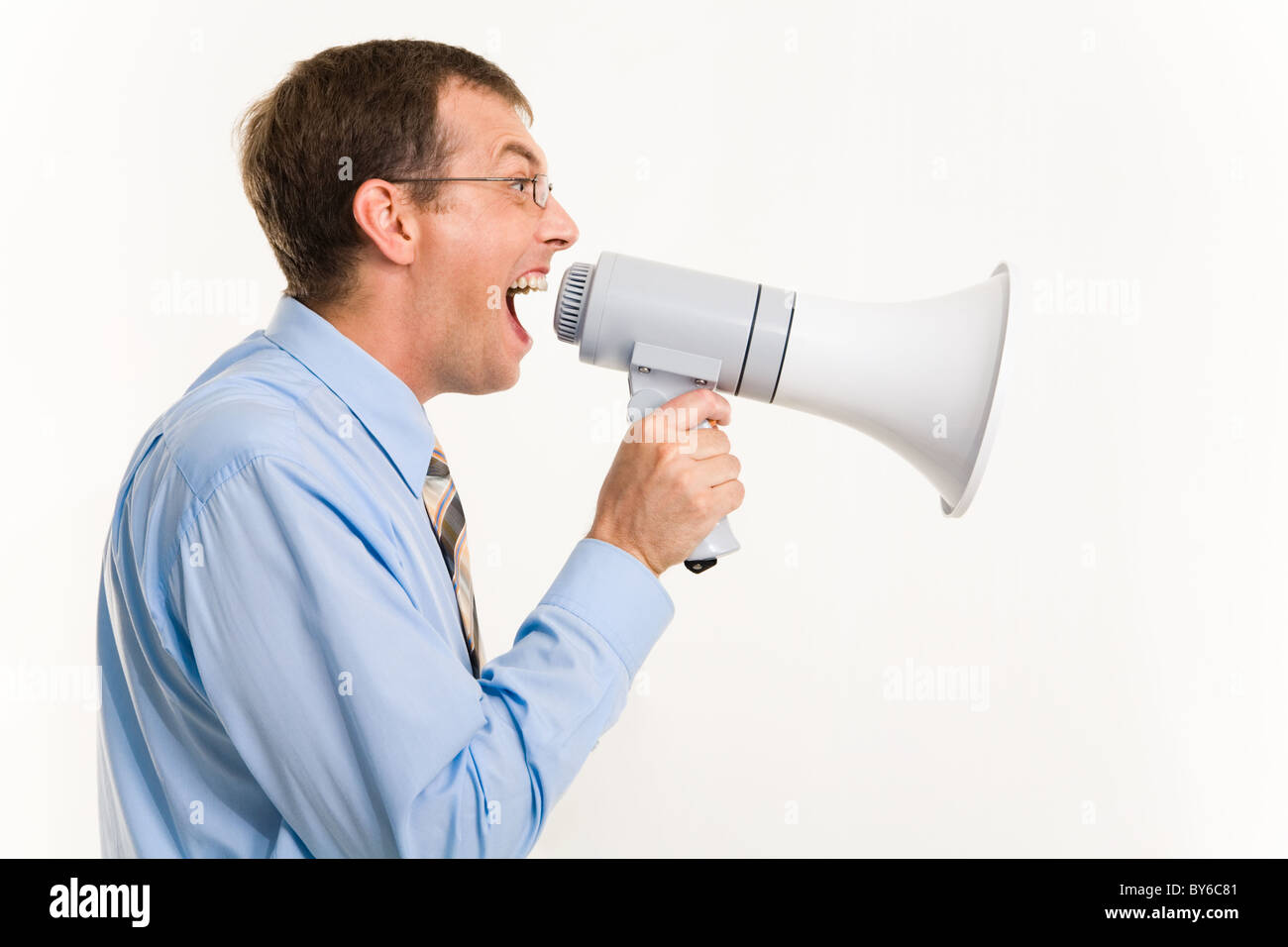 Profile of man shouting through megaphone isolated over white ...