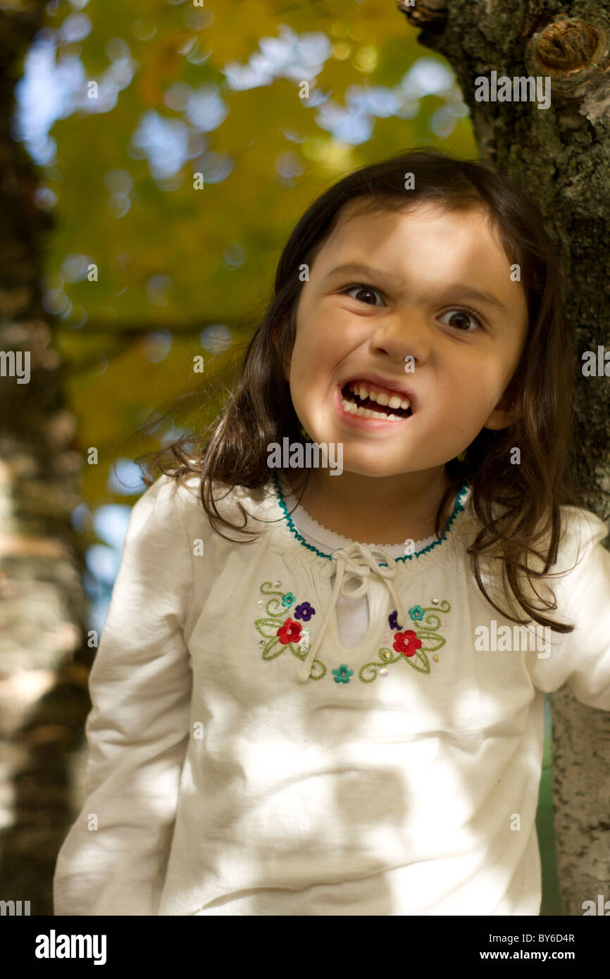 Mixed child pulling a funny face Stock Photo - Alamy