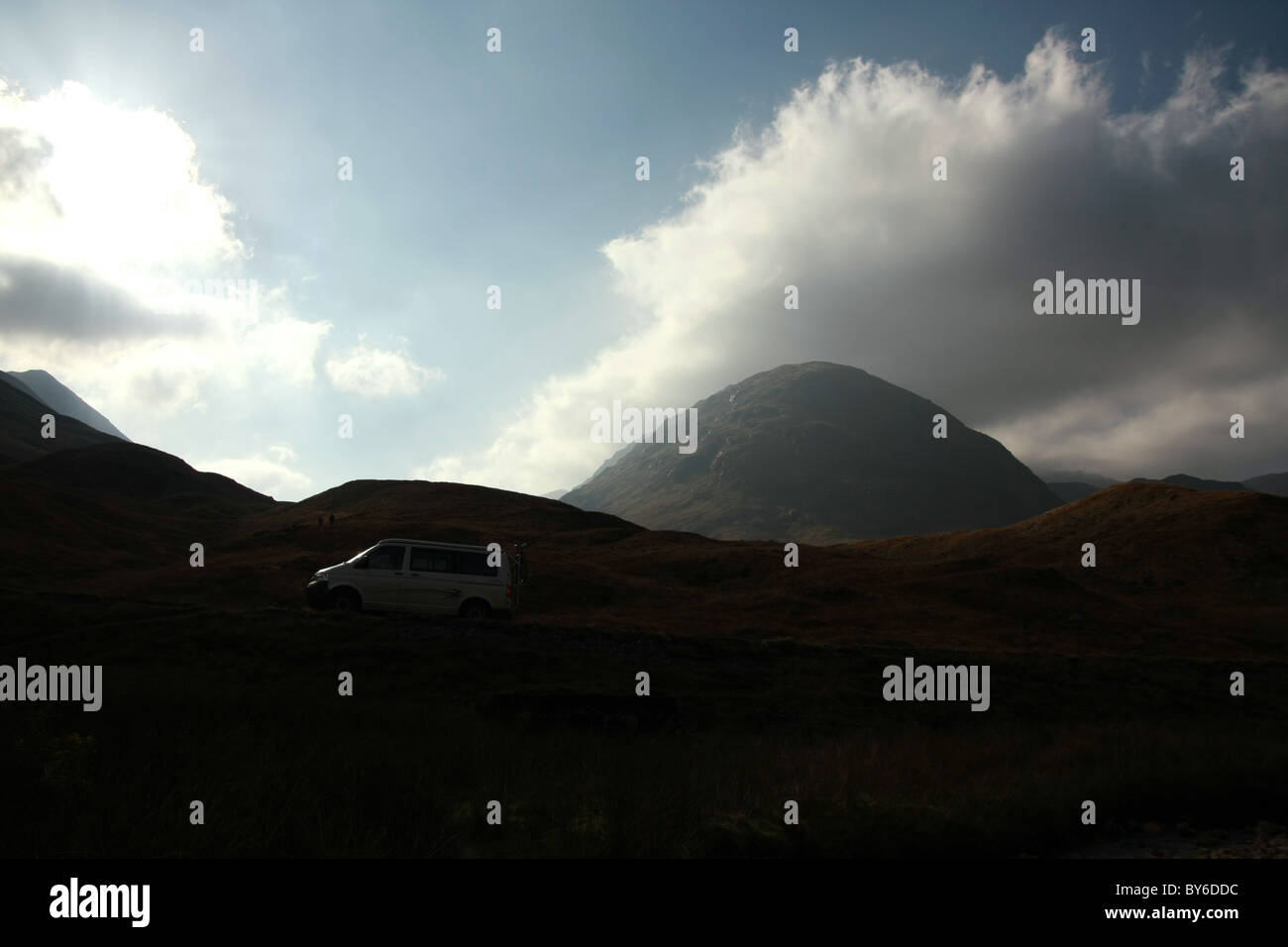 A dramatic mountain scene from the Highlands of Scotland, with a camper ...