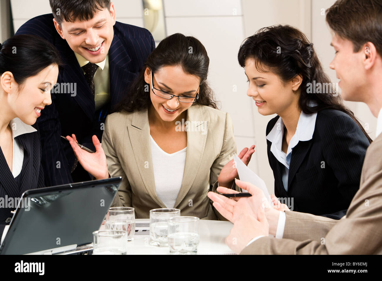 Image of successful businesswoman with four colleagues looking at plan ...