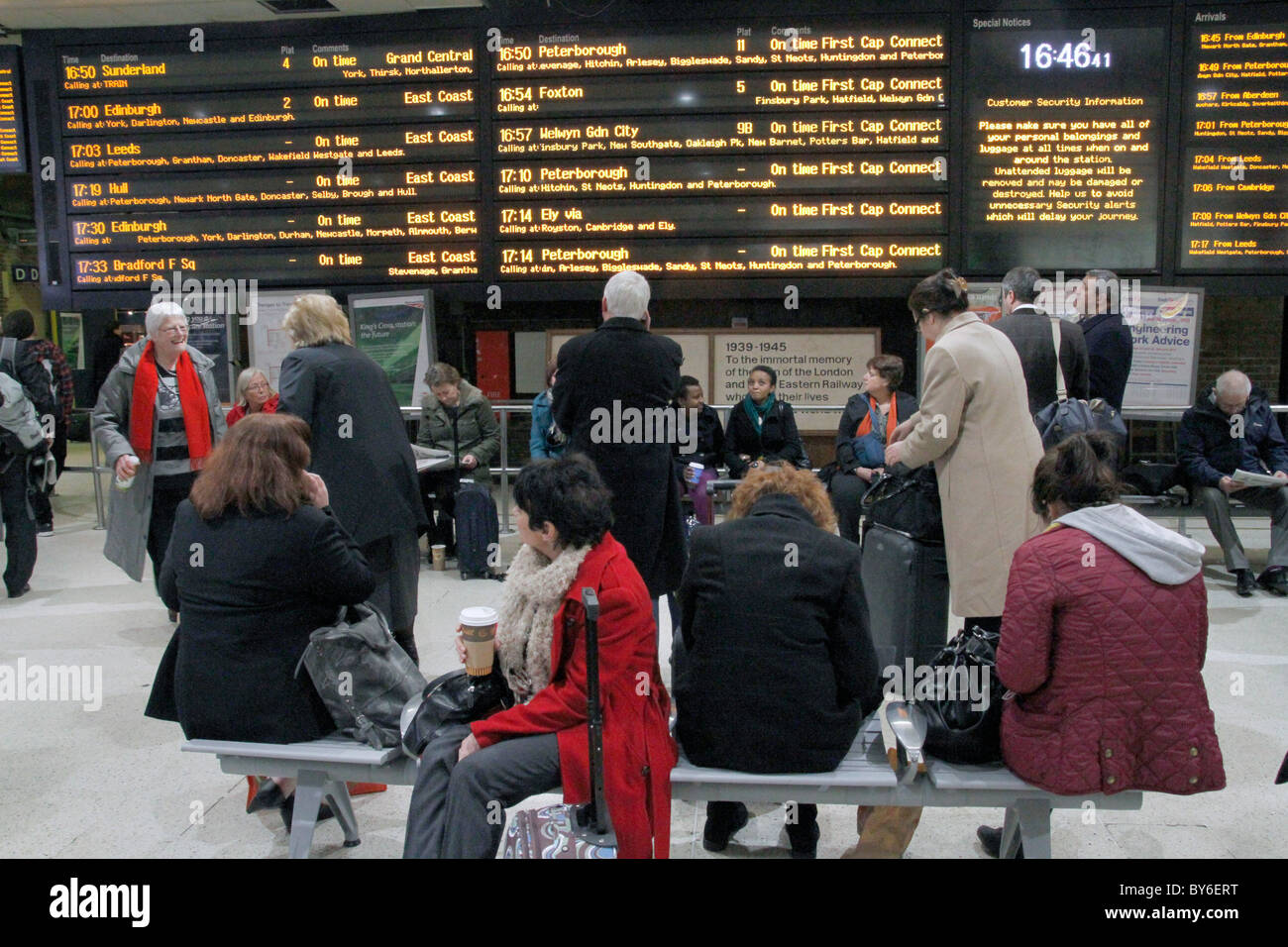 UK.Passengers checking the train timetable during rush hour at London's ...
