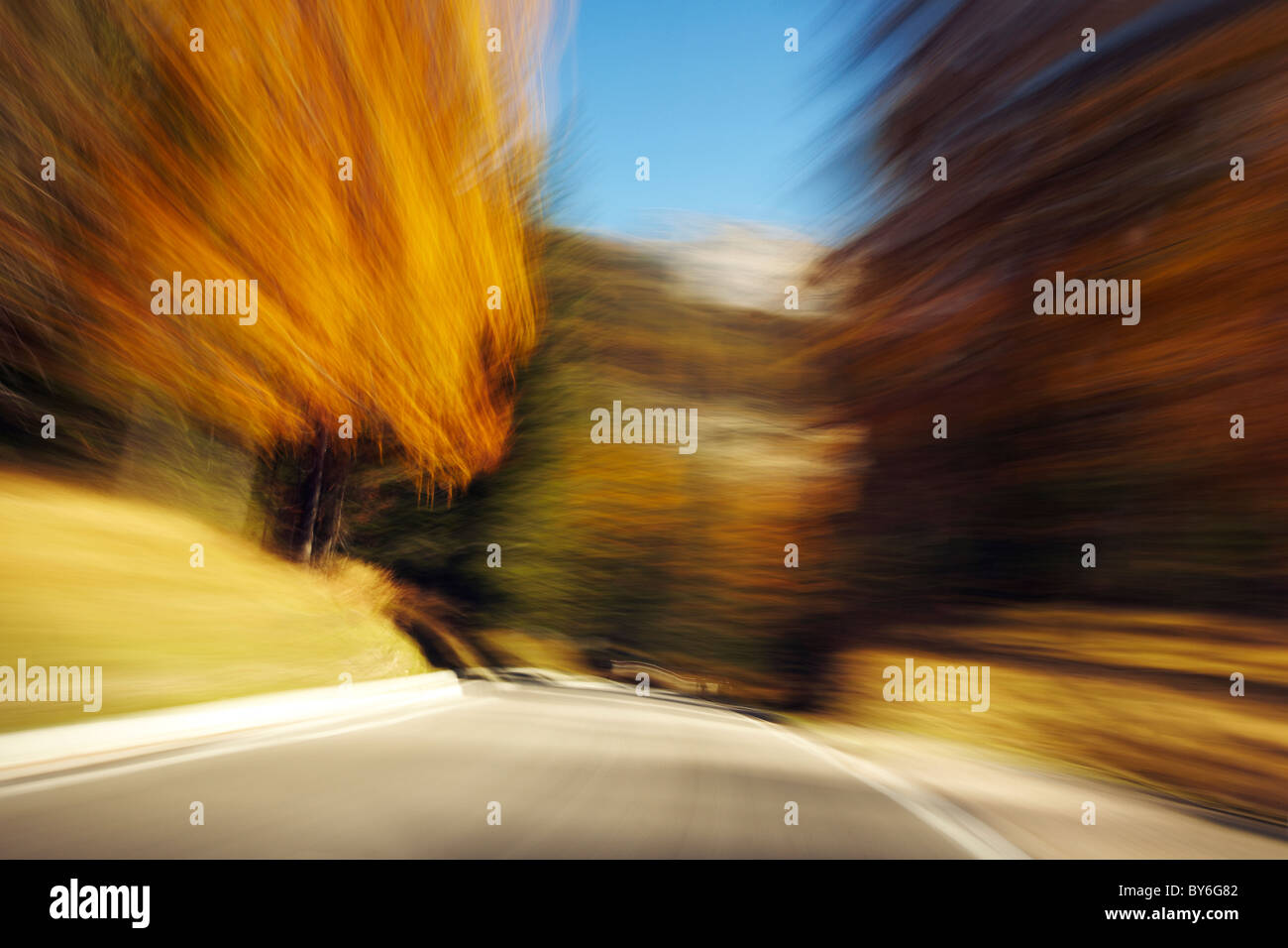 Speed on mountain road in fall Stock Photo - Alamy