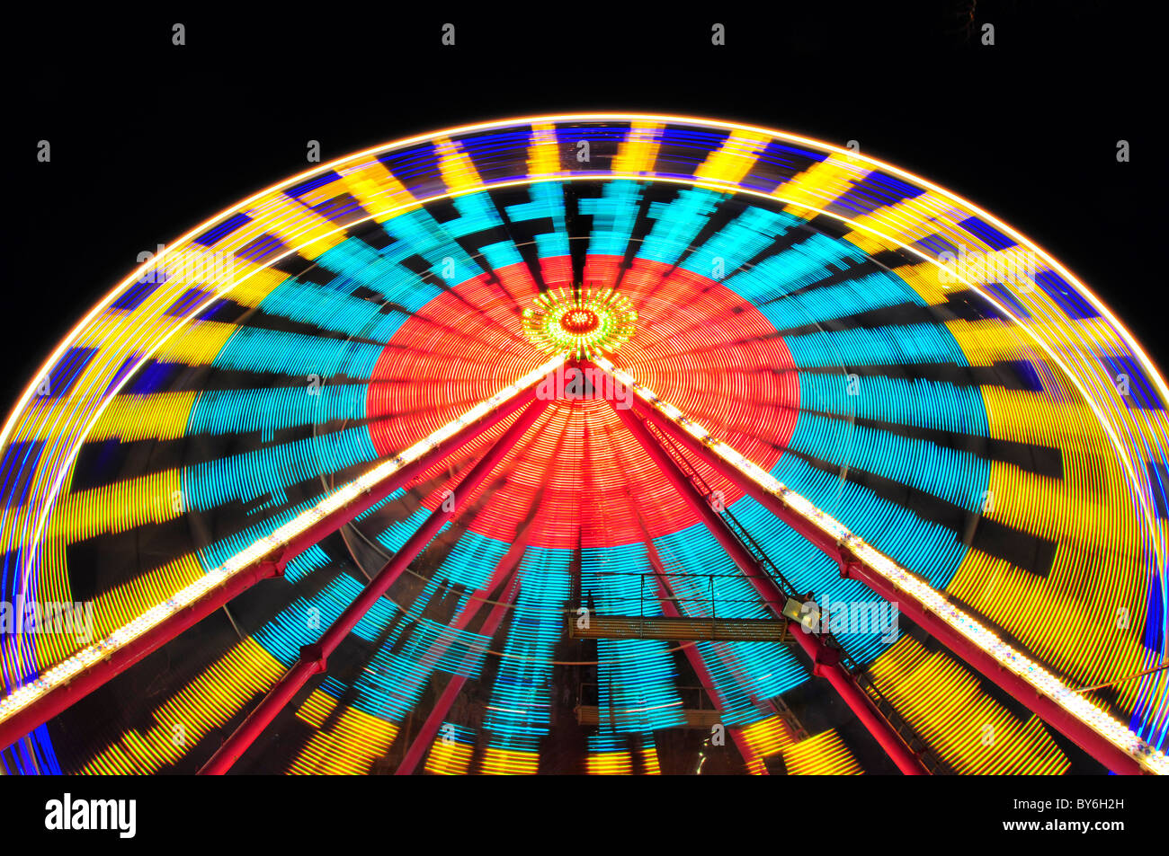 Funfair rides by night with light trails Stock Photo - Alamy