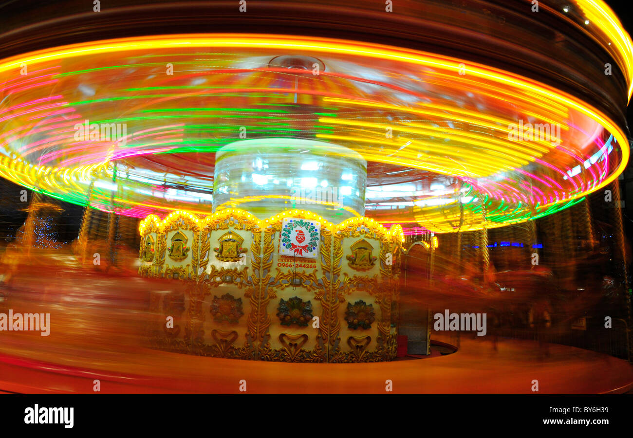 Funfair rides by night with light trails Stock Photo - Alamy