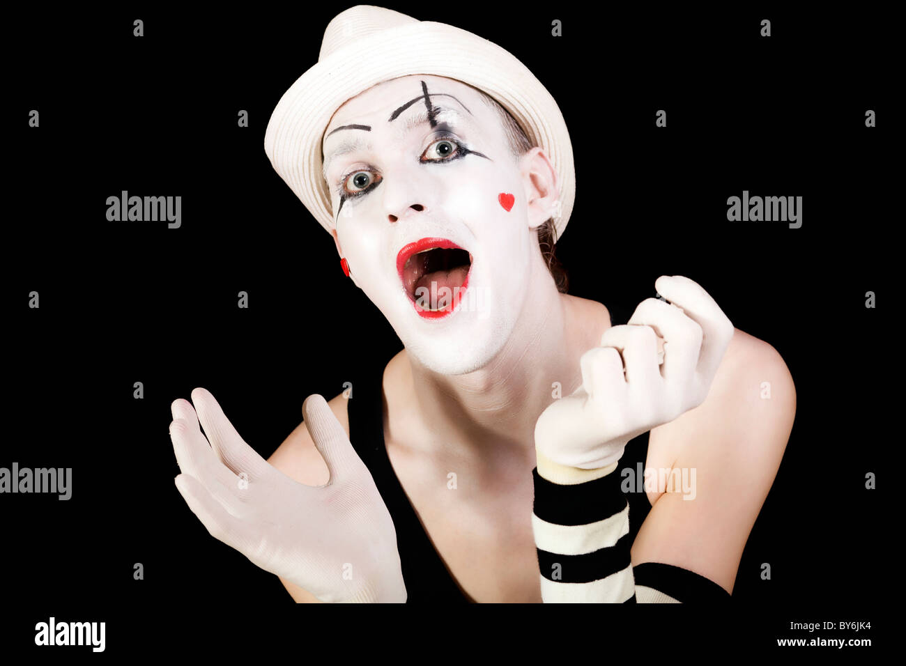 Funny screaming mime in white hat isolated on black background Stock ...