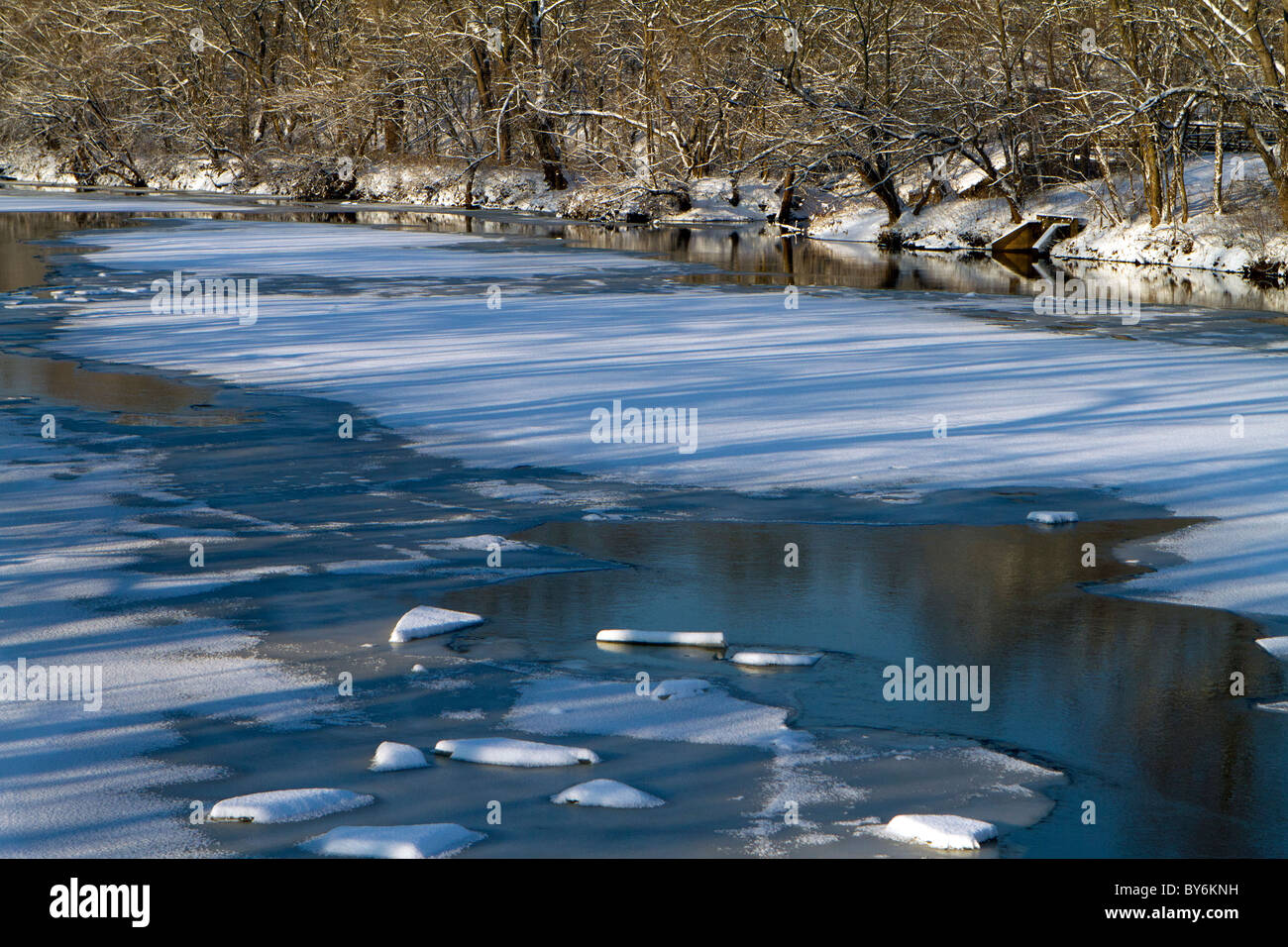 A winter river scene. Ice and ice blocks and frozen trees Stock Photo ...