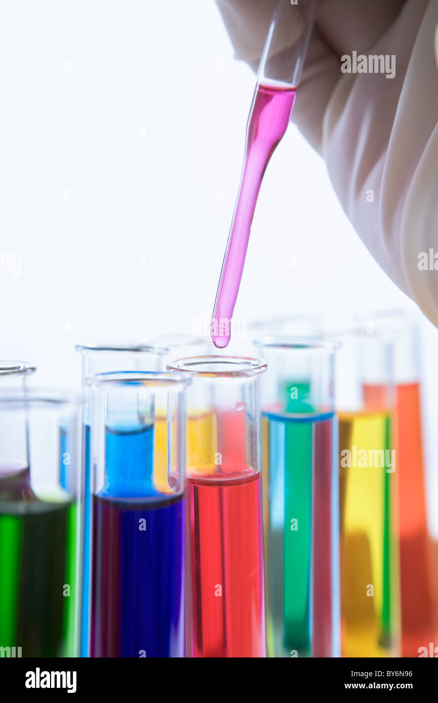 Mixing carefully chemical solution into the test tube Stock Photo - Alamy
