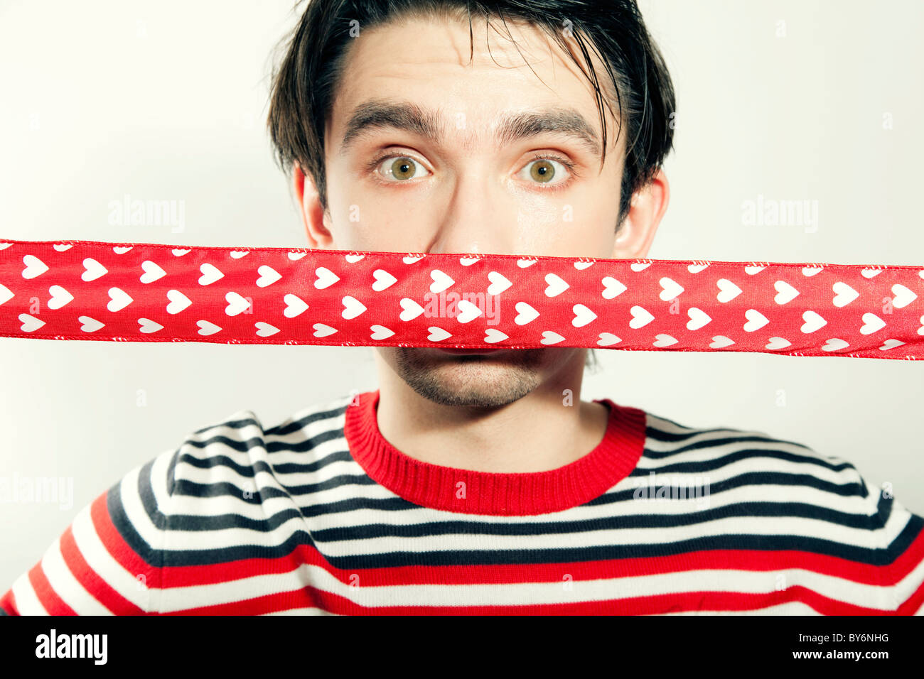young guy with a ribbon at the mouth on a white background Stock Photo ...