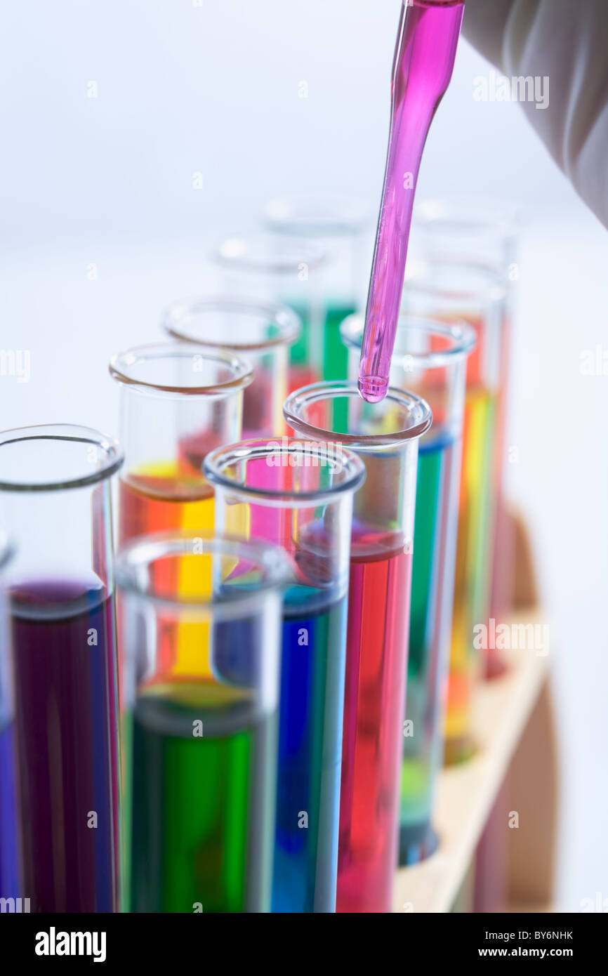 Mixing carefully chemical solution into the test tube Stock Photo - Alamy