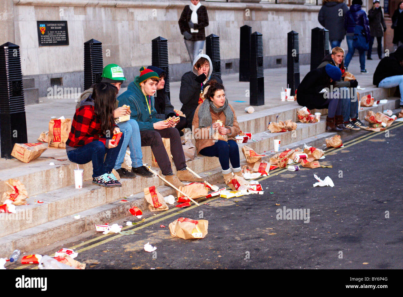 Demonstrators eat a McDonalds meal surrounded by litter during a ...